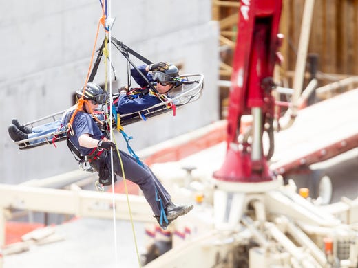 Firefighters dangle high in the sky for rescue training