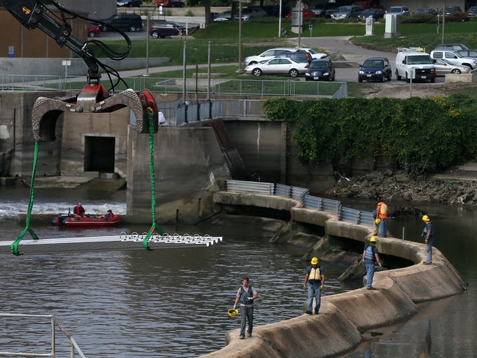 22 photos: City workers add flashboards in Center Street Dam