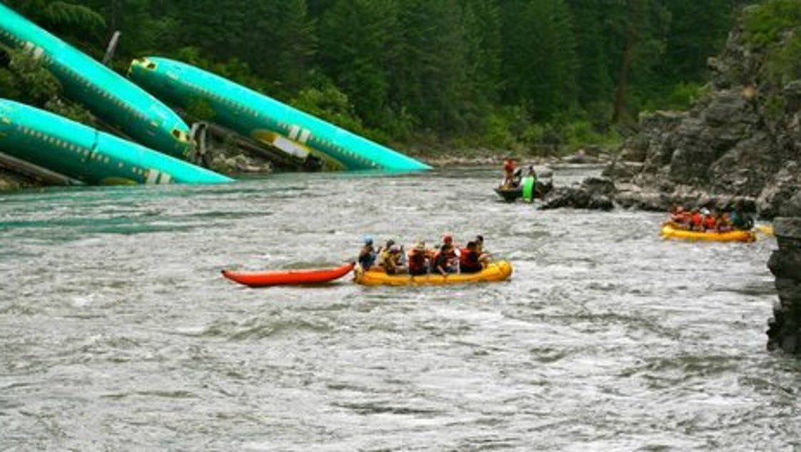 Train derailment spills Boeing 737 fuselages into river