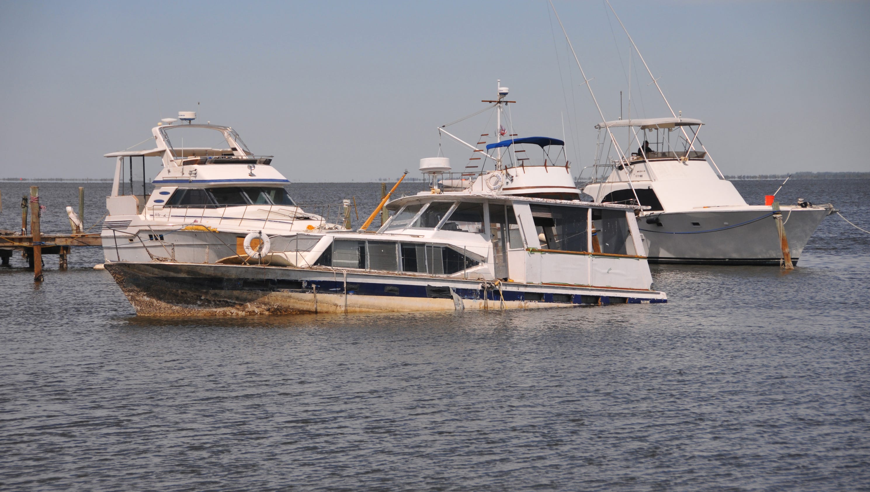 Derelict boats from hurricanes continue to litter local waters