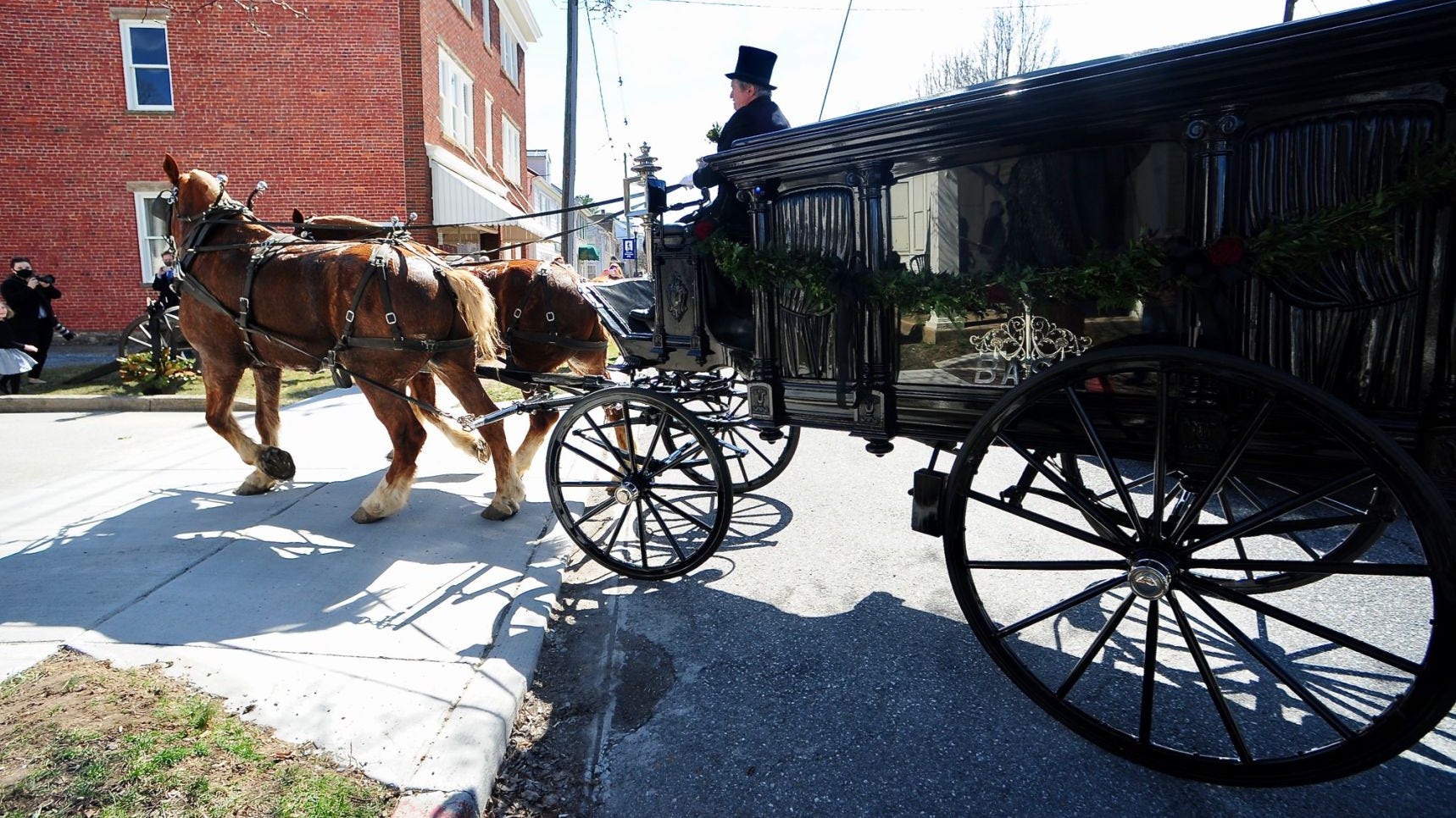 Horse-drawn funeral carriage carries Doug Bast's remains through Boonsboro