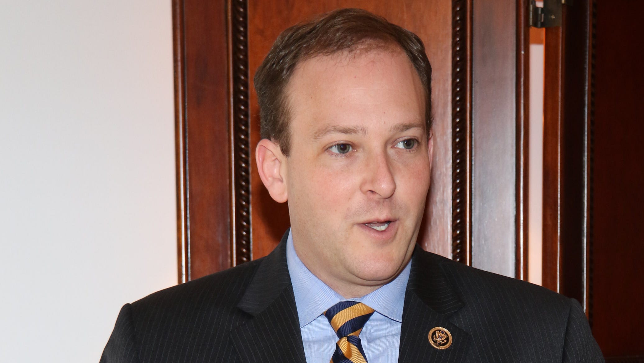 Endangered GOP congressman fears not, embraces Trump