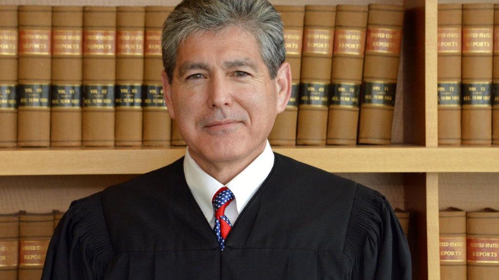 Judge says reuniting families is government’s burden