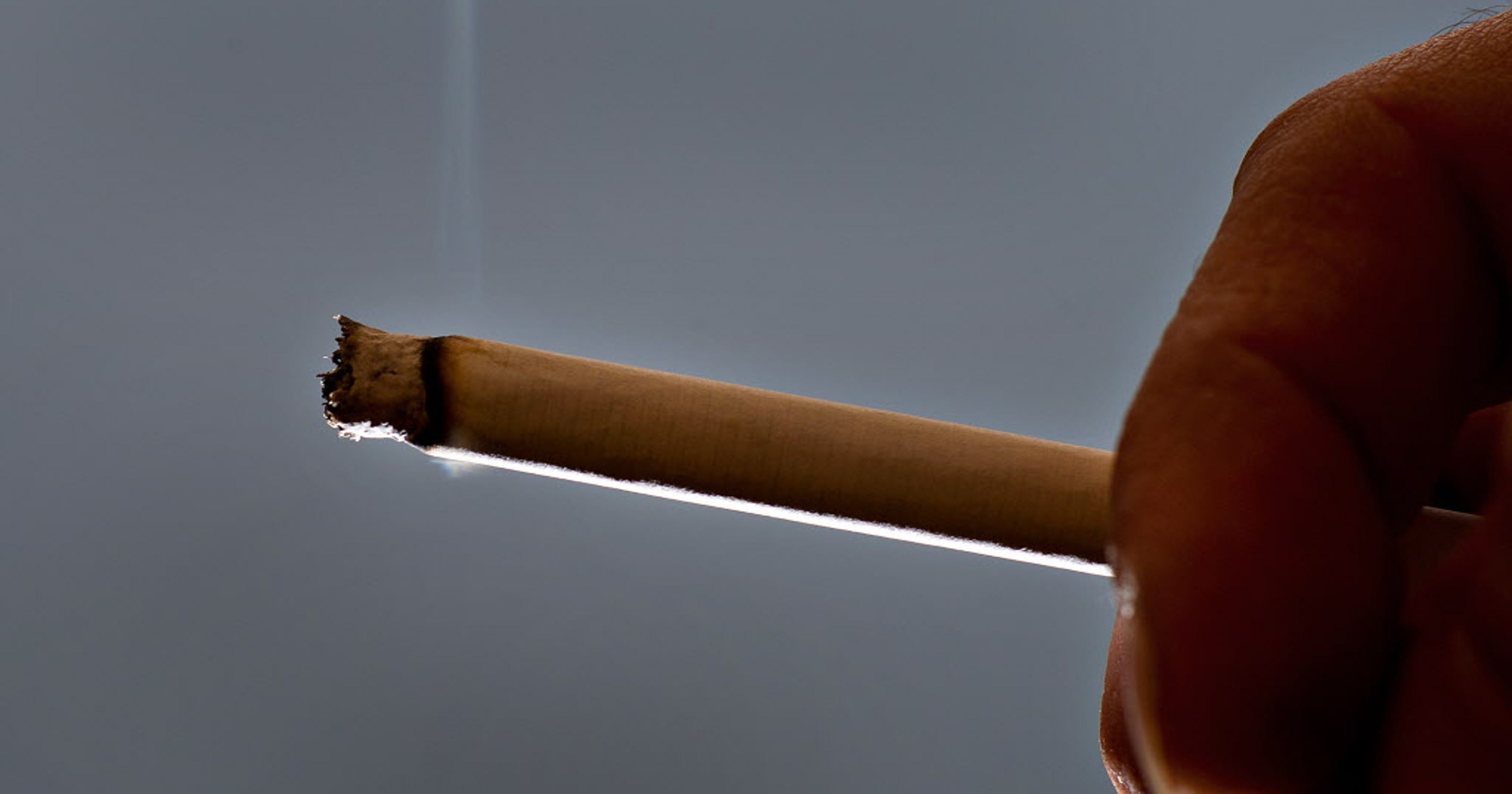 Man drops cigarette, runs over own head