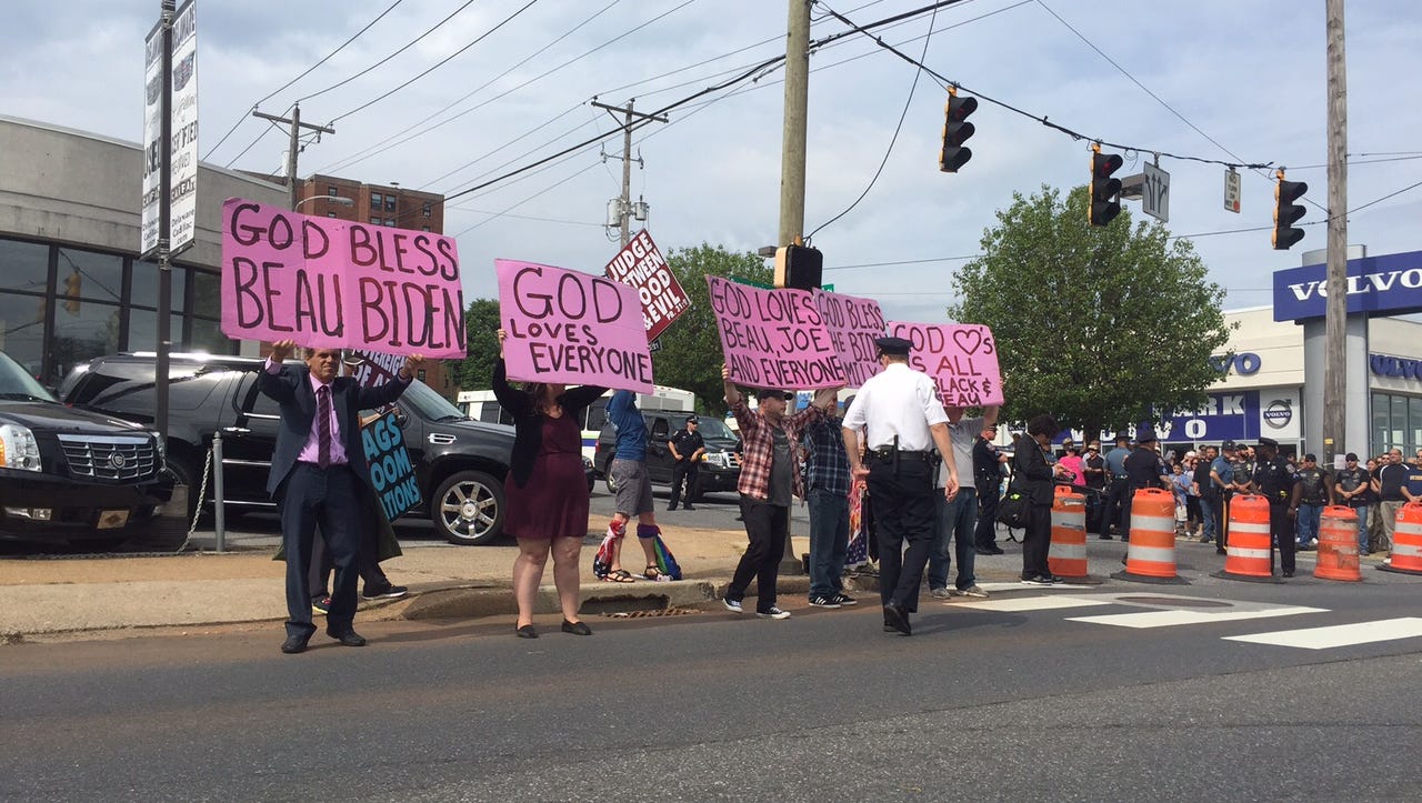 Protesters against the Westboro Baptist protest line the streets.