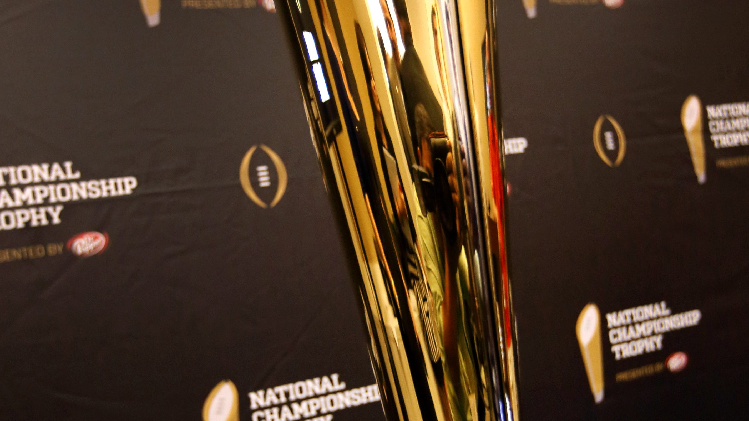 College football shows off new golden trophy for playoff champion