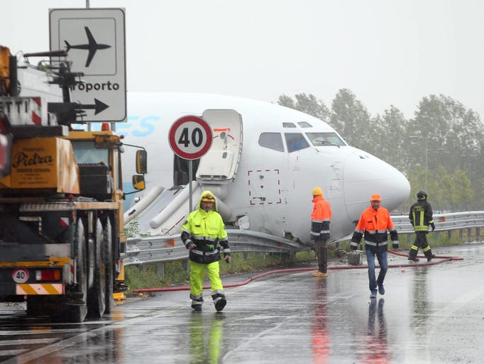A DHL cargo jet crashed onto a road in Italy after overshooting runway