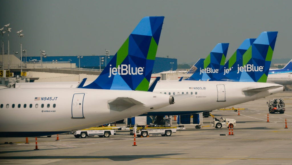 Jet Blue planes at gates at New York's John F. Kennedy Airport on June ...