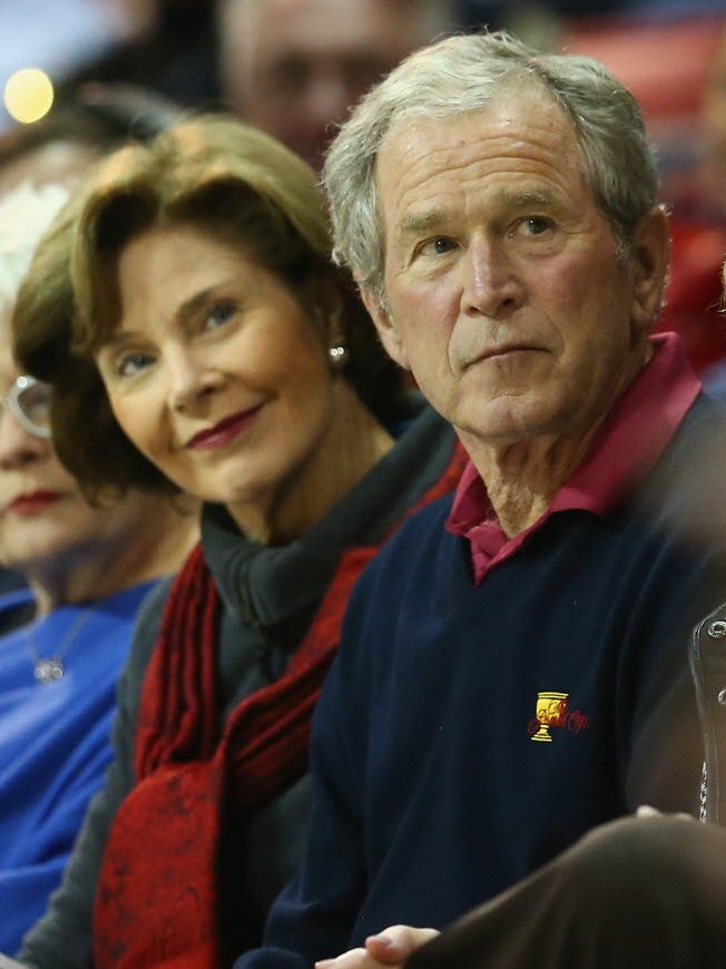 Former President George W. Bush and his wife, Laura, attend a game ...