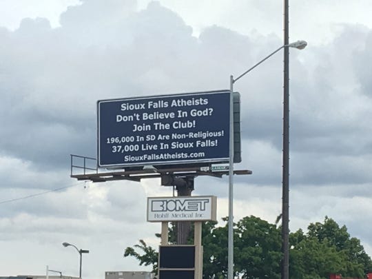 Atheist billboard ripped along center; group founder blames vandalism