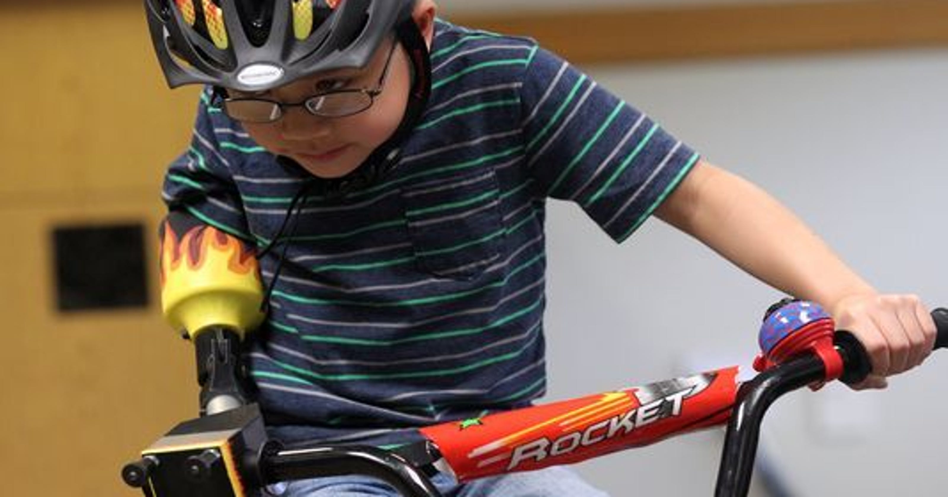 Watch boy with one arm ride bike for the first time