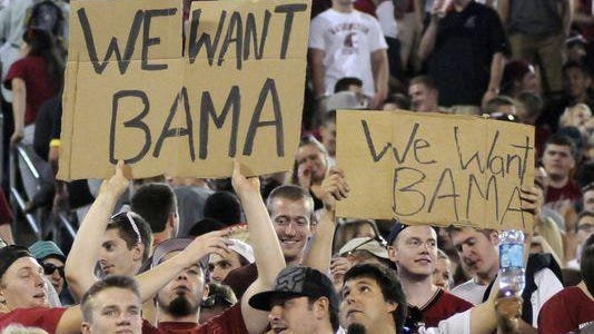 Utah State fan holds up 'We Want Bama' sign; Alabama favored by 41.5