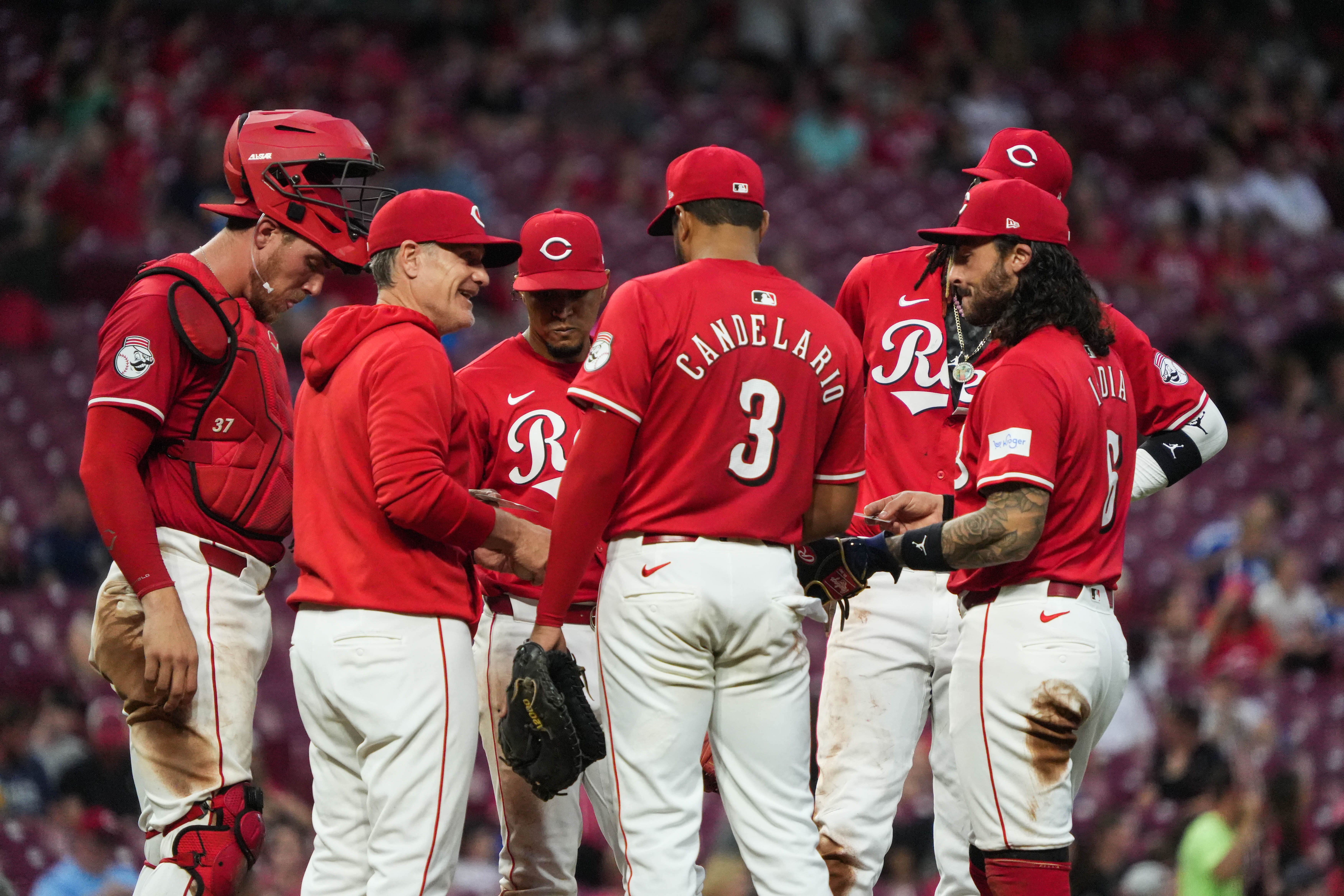 Reds players meet at the mound during the Reds vs. Diamondbacks game on ...