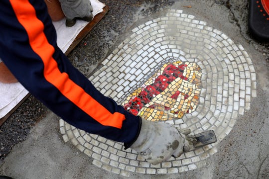 Artist Jim Bachor turning Eastern Market potholes into art