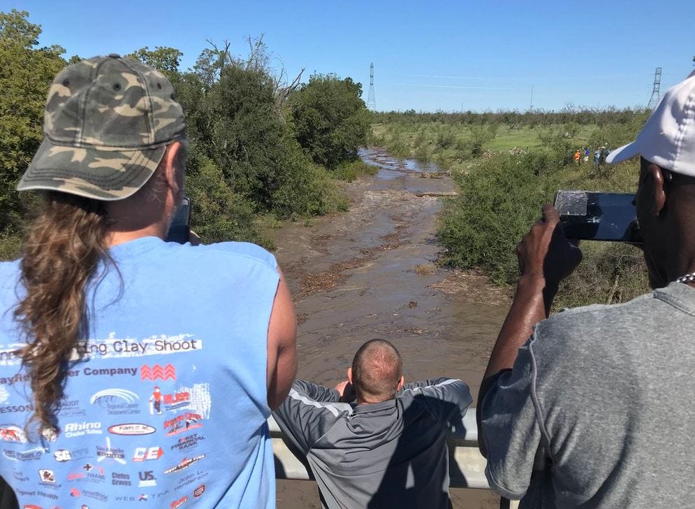 Crowd watches North Concho River flood waters reach Grape Creek