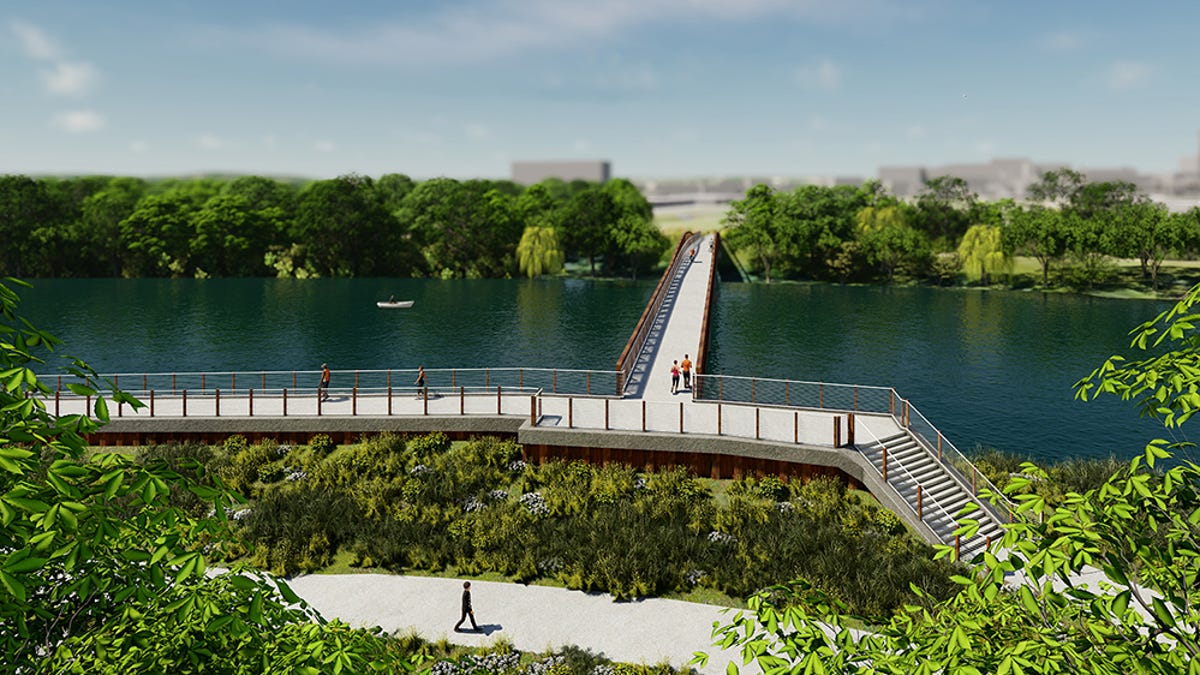 See a pedestrian bridge connecting downtown Des Moines to Gray's Lake