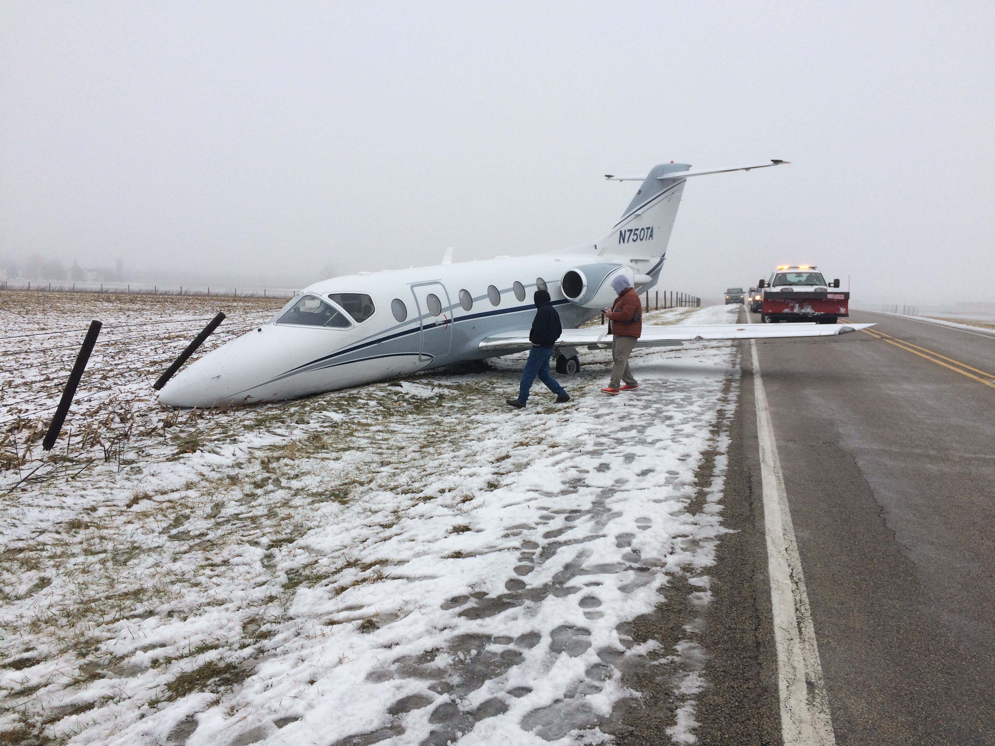 Indiana plane slides on snowy runway, across highway