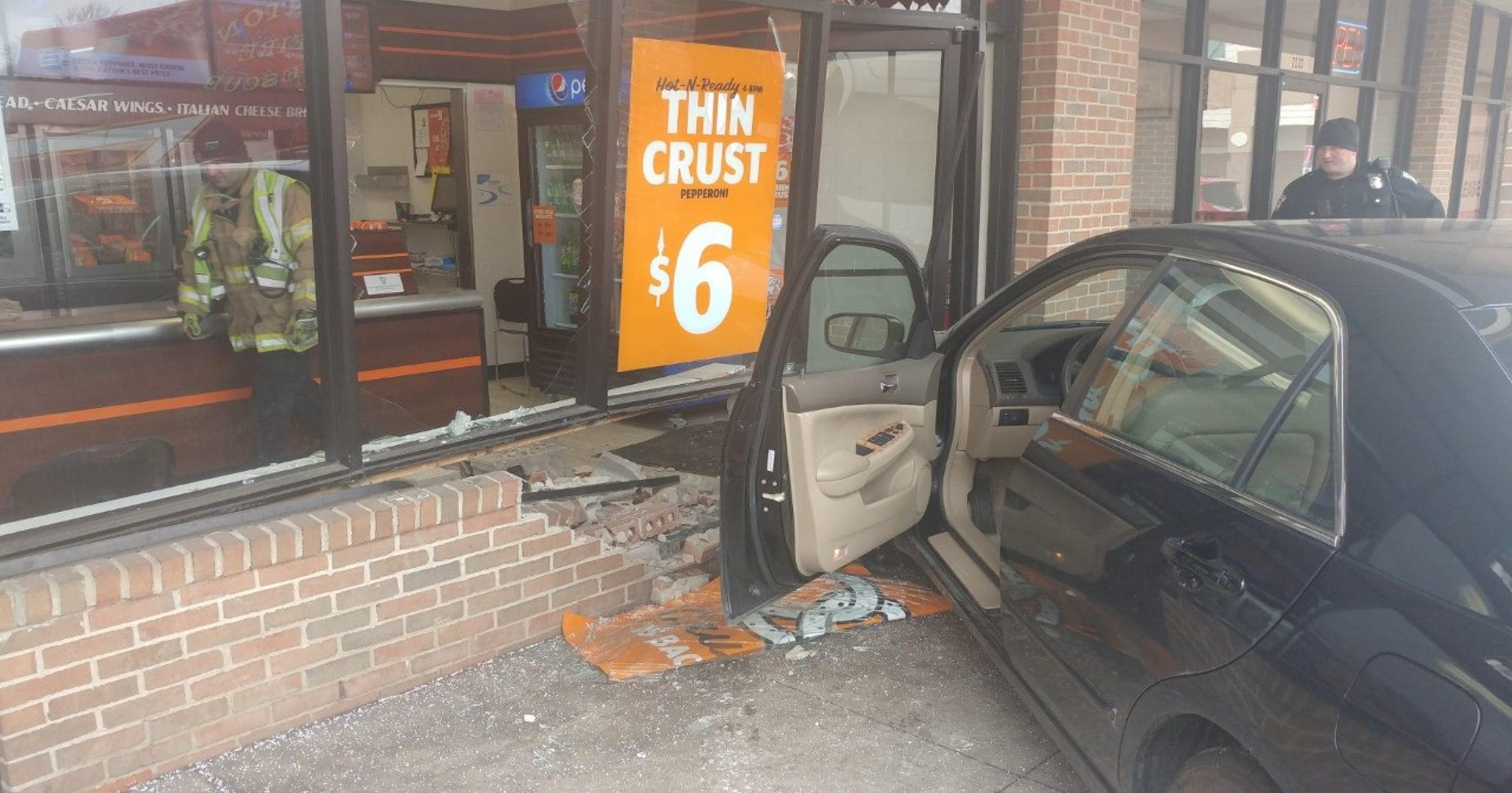 Car crashes in to Little Caesars building