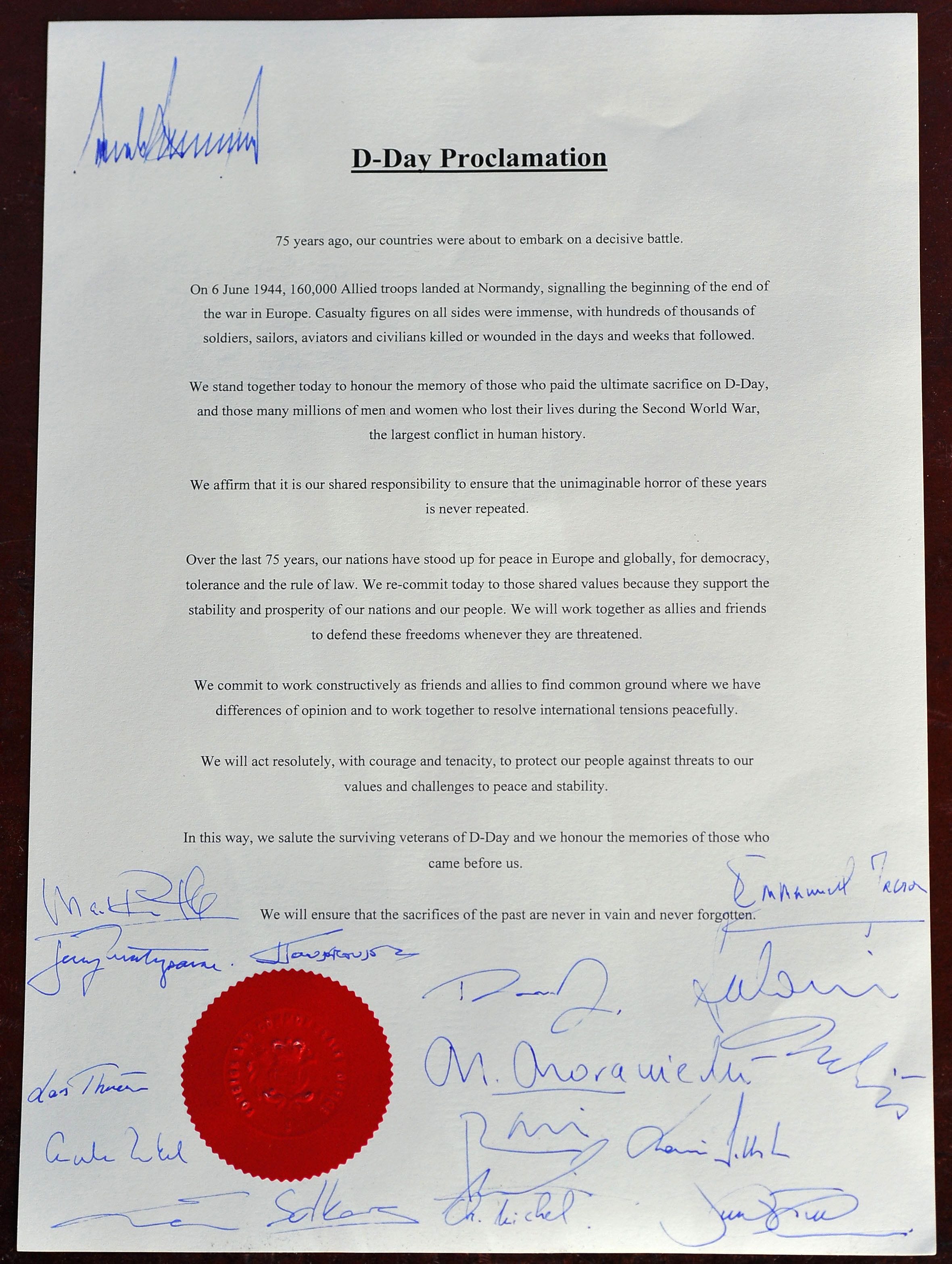 Trump signs D-Day proclamation at top, other leaders sign at bottom