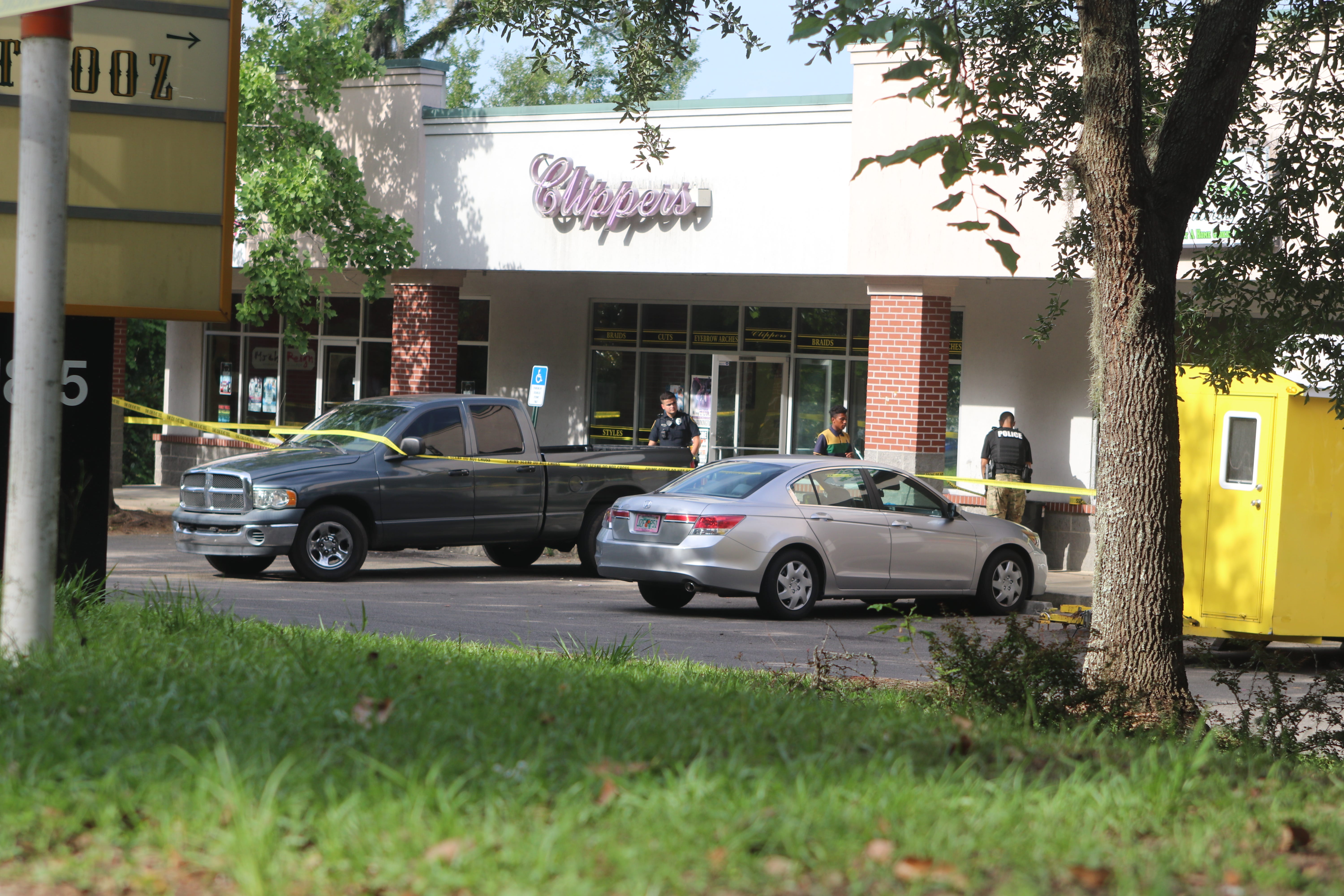 Barbershop shooting: Suspect put gun to child's head, police say