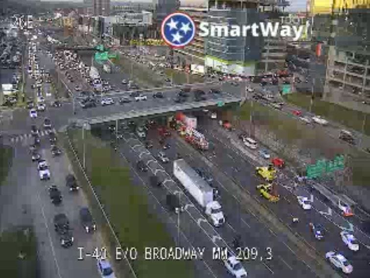 Driver in critical condition after car smashed between semi trucks on I-40