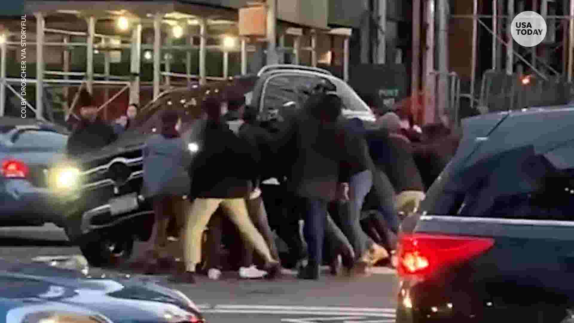 Strangers stop to save a woman stuck under an SUV in New York City