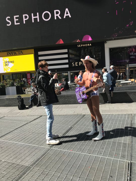 Times Square, emptied but alive, becomes a refuge from coronavirus
