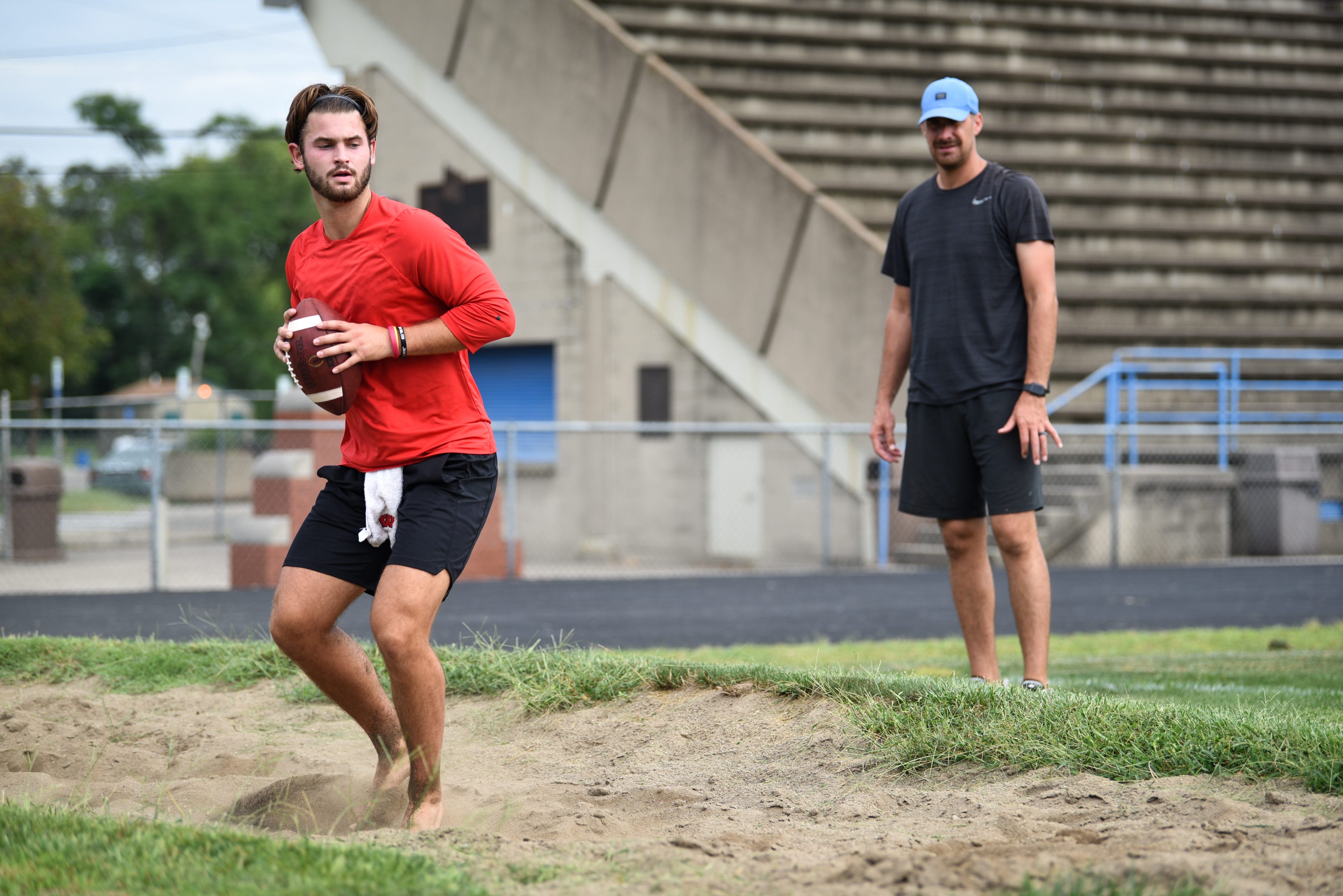 Wisconsin QB Chase Wolf works with Tony Pike after Big Ten pulls plug