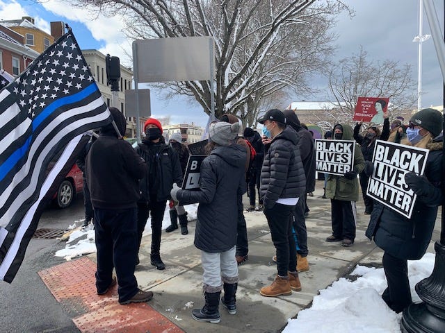 BLM and thin blue line flag face off peacefully on the Taunton Green