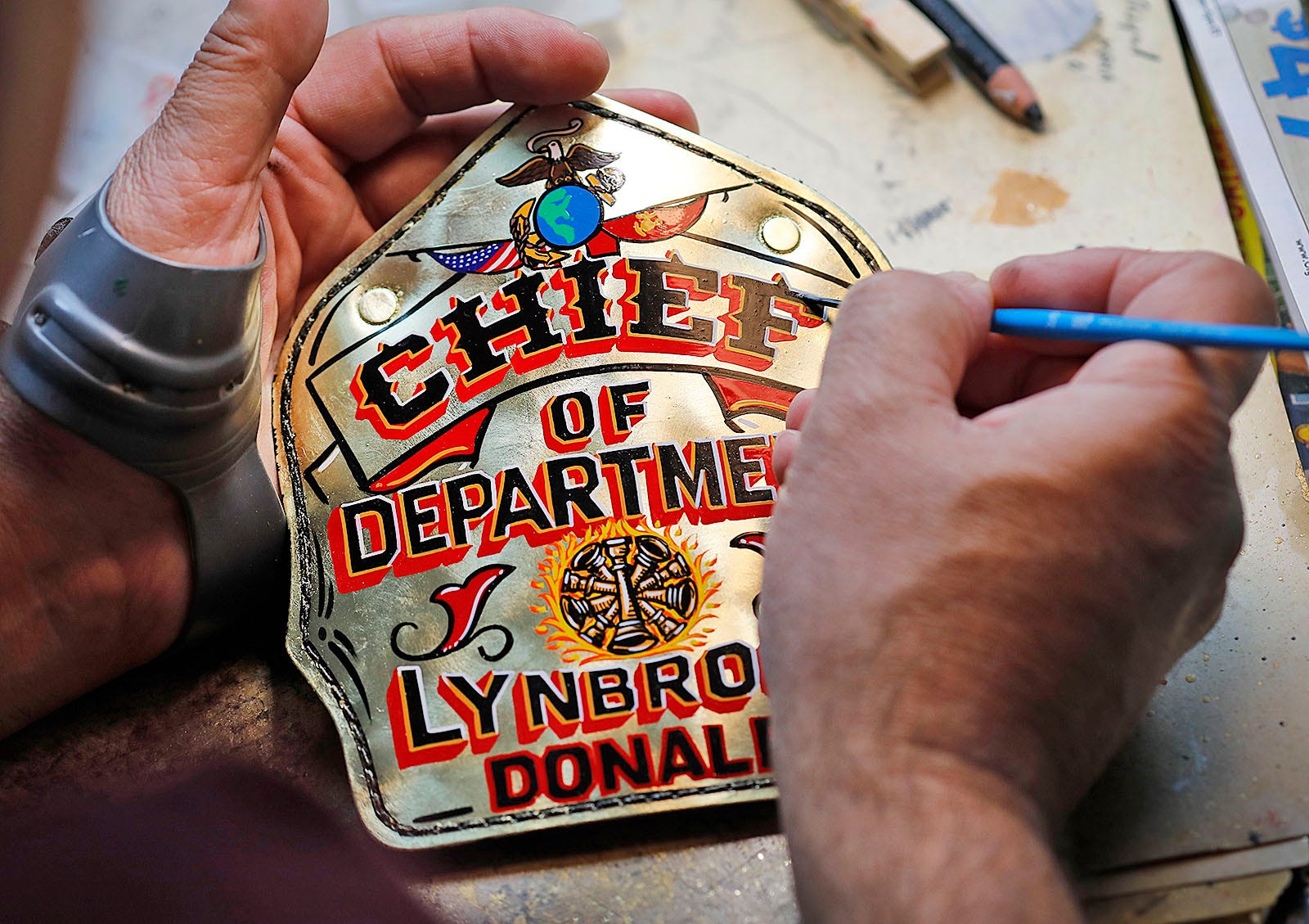 Weymouth artist paints helmet shields for firefighters across the country
