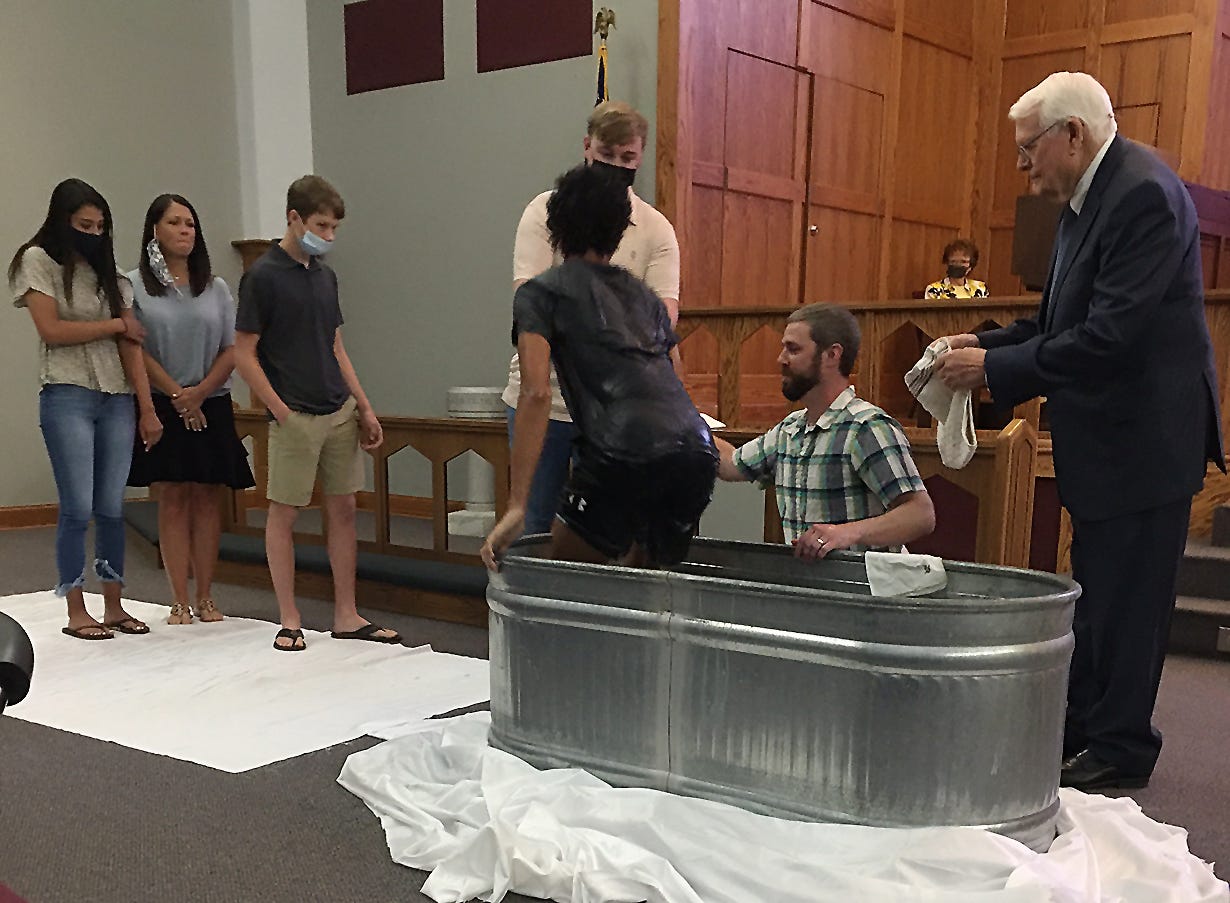 Methodist church uses water trough for baptism sacrament