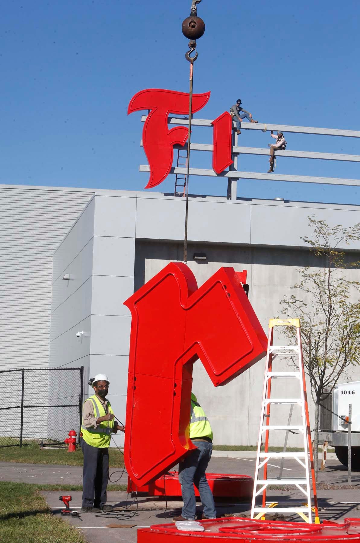 Bridgestone hoists historic Firestone sign atop new Akron tire plant