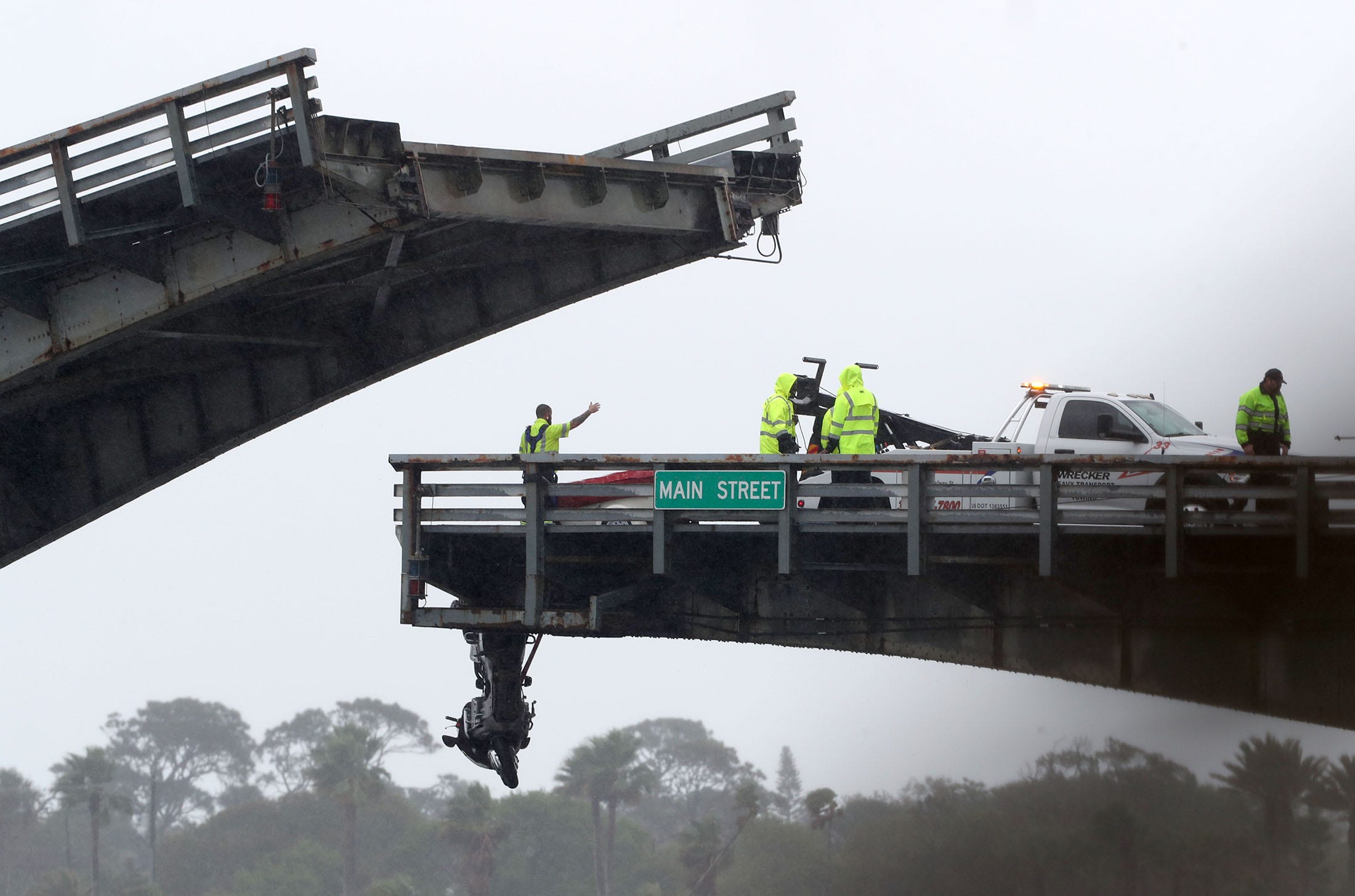 Motorcycle dangling from Main Street bridge in Daytona Beach