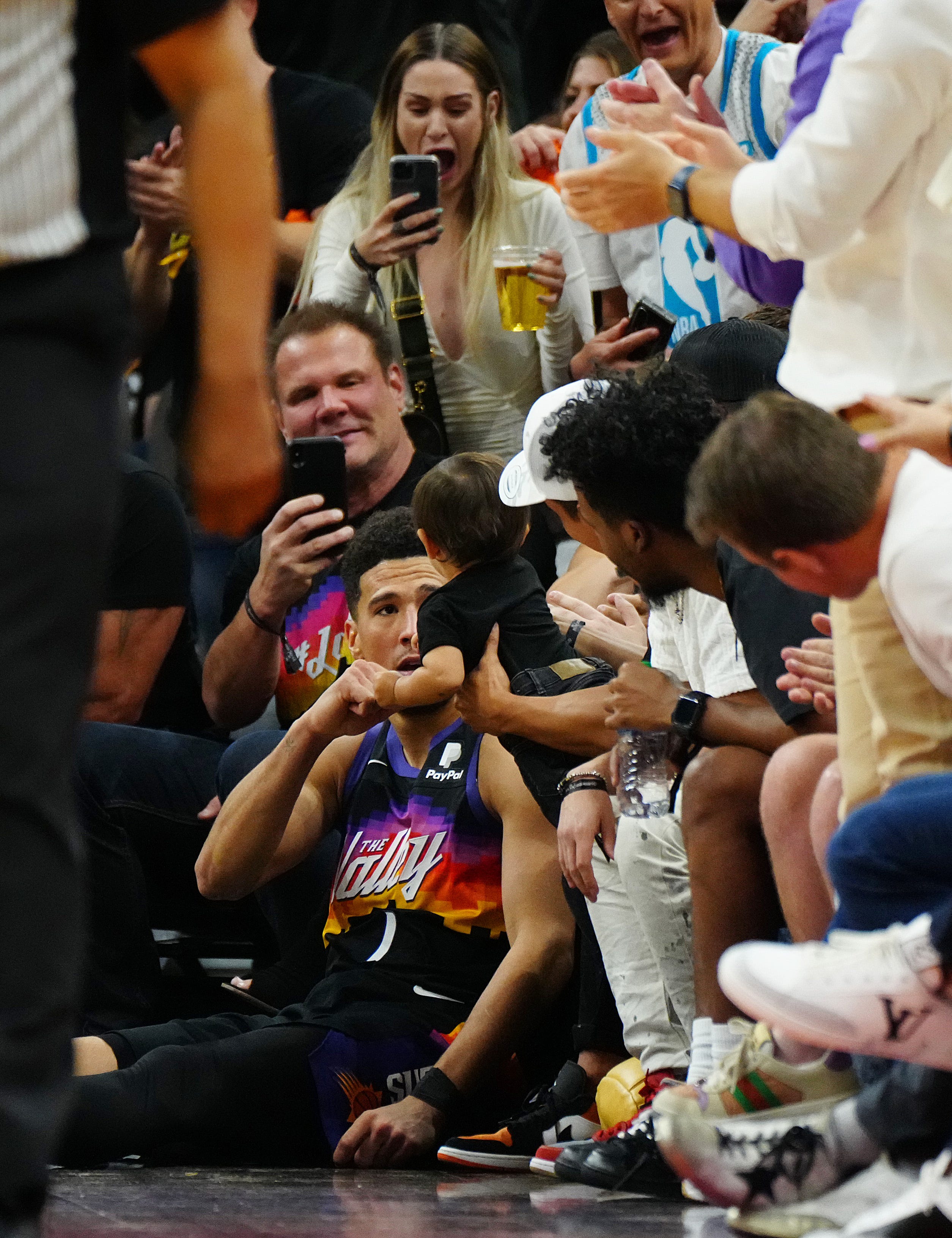 Phoenix Suns' Devin Booker fist-bumps baby in NBA Playoffs Game 2 loss
