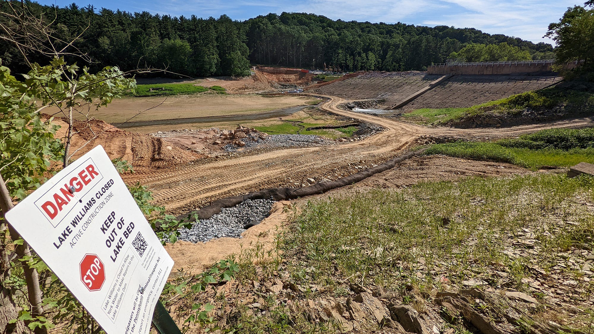 Lake Williams dam excavation under way, empty lake bed turns green