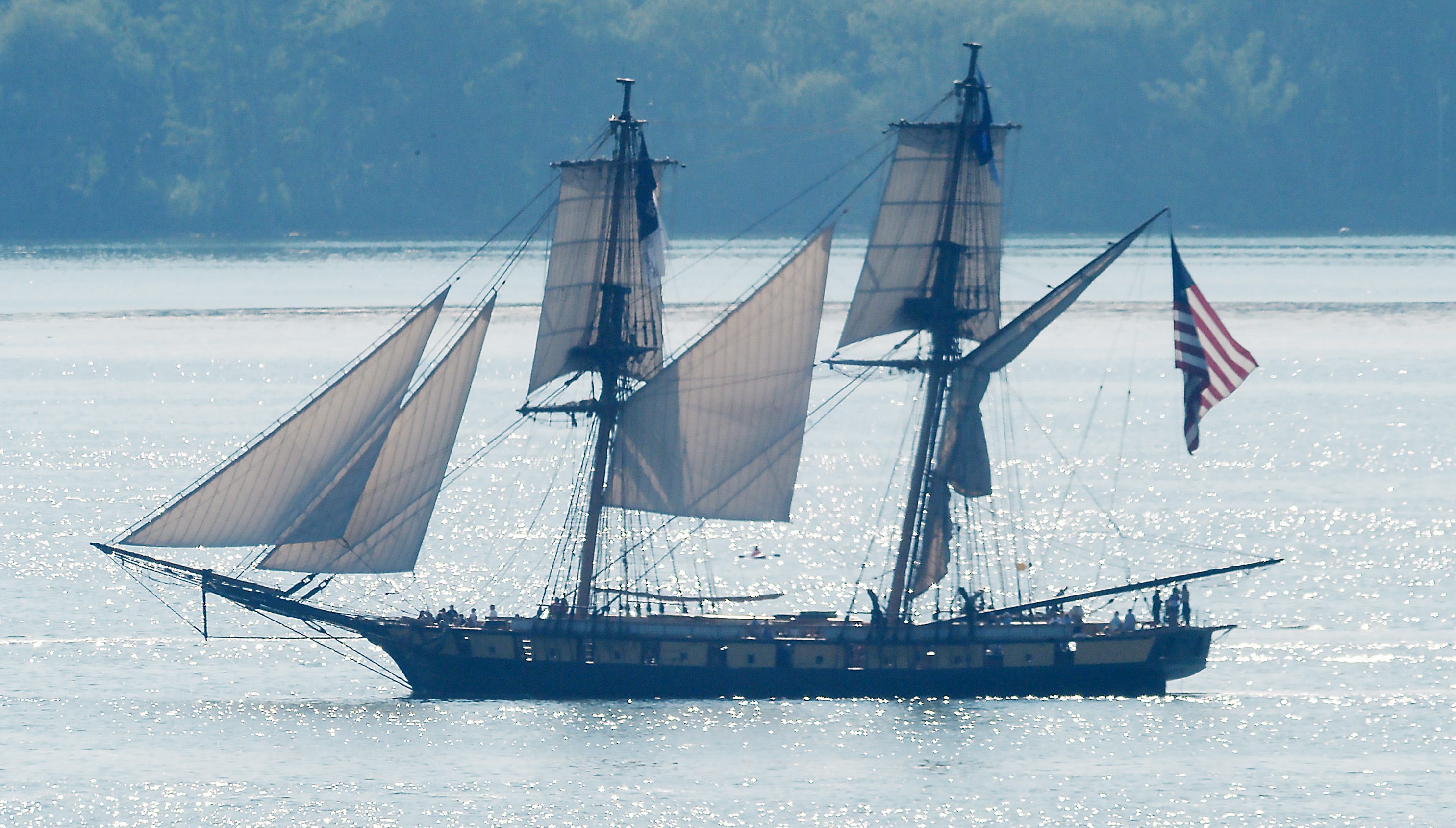 U.S. Brig Niagara crew raise the American flag at ship's stern