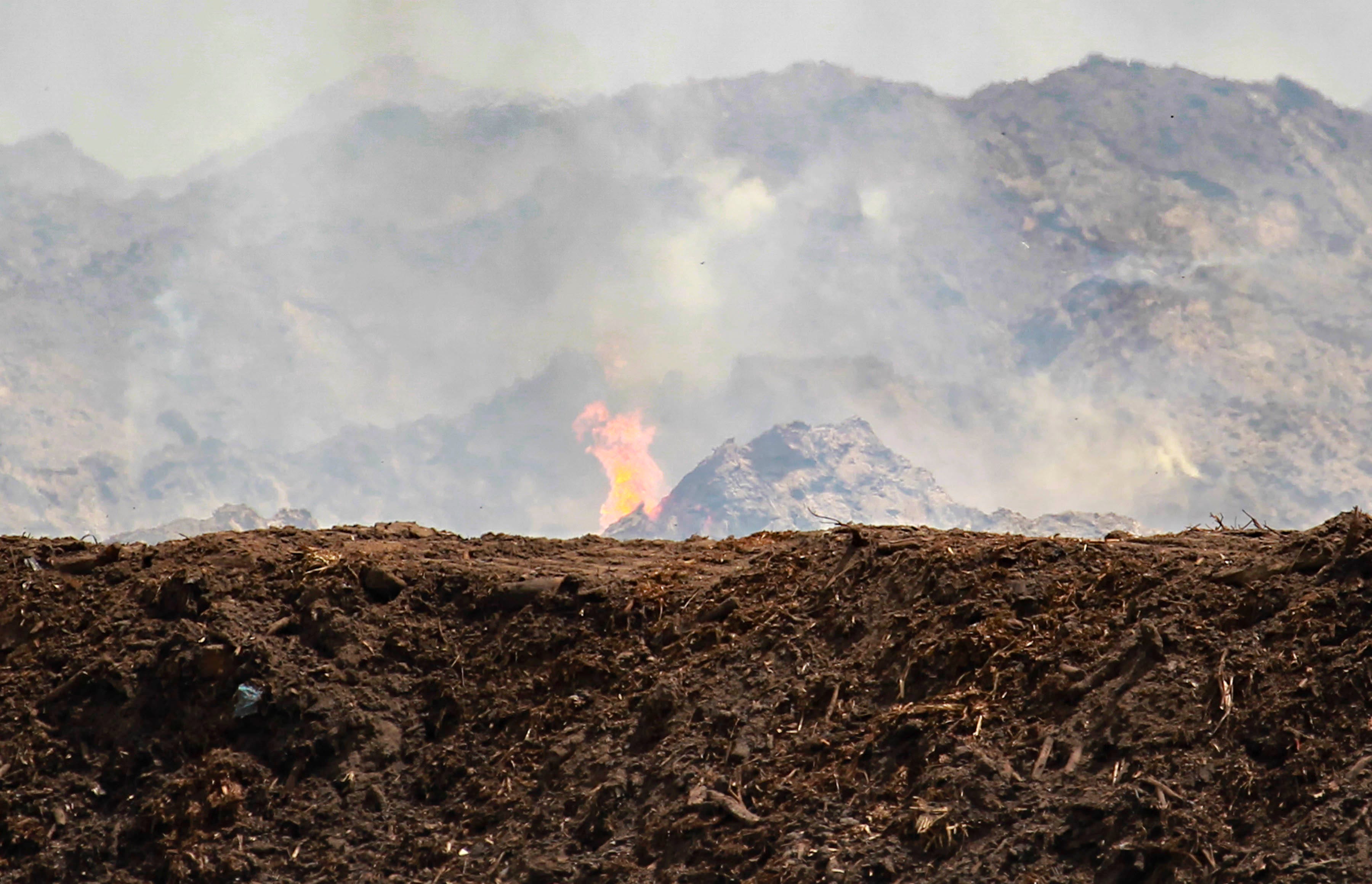 Rain, smoke as millions of gallons of water are delivered to vegetative ...