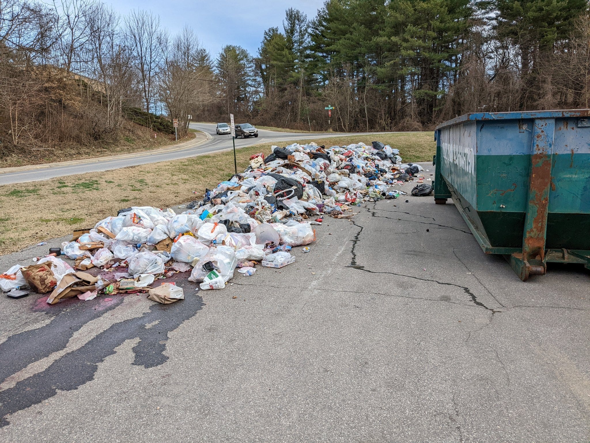 Asheville parking lot trash dump a crime? Harmful to Hominy Creek?